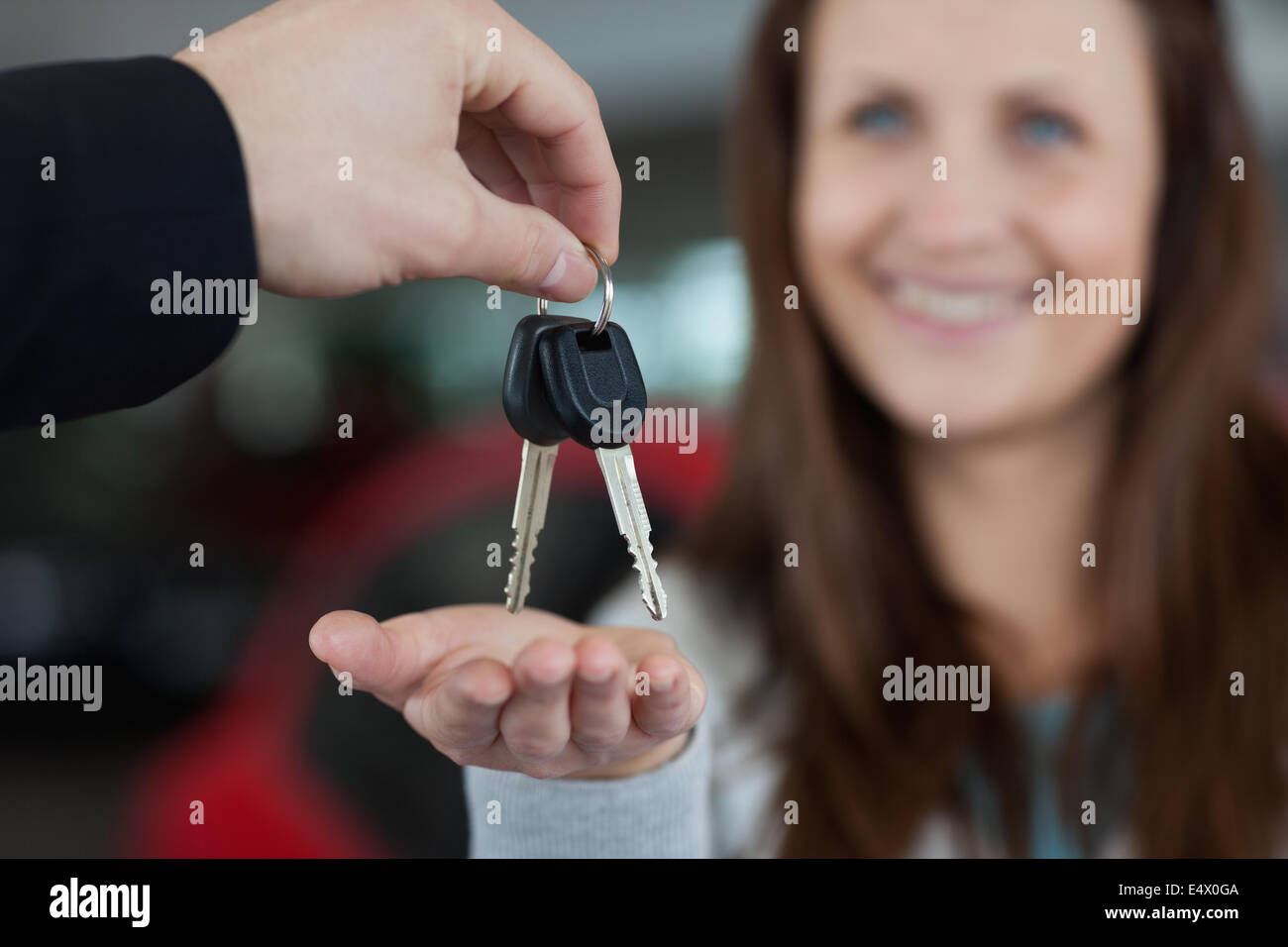 Woman smiling while receiving car keys Stock Photo - Alamy