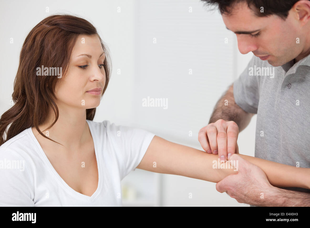 Doctor examining the arm of a patient Stock Photo - Alamy