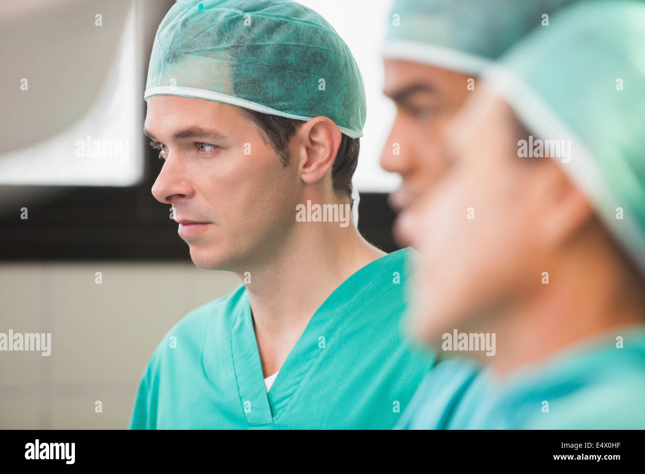 Three surgeons in operating theatre Stock Photo - Alamy