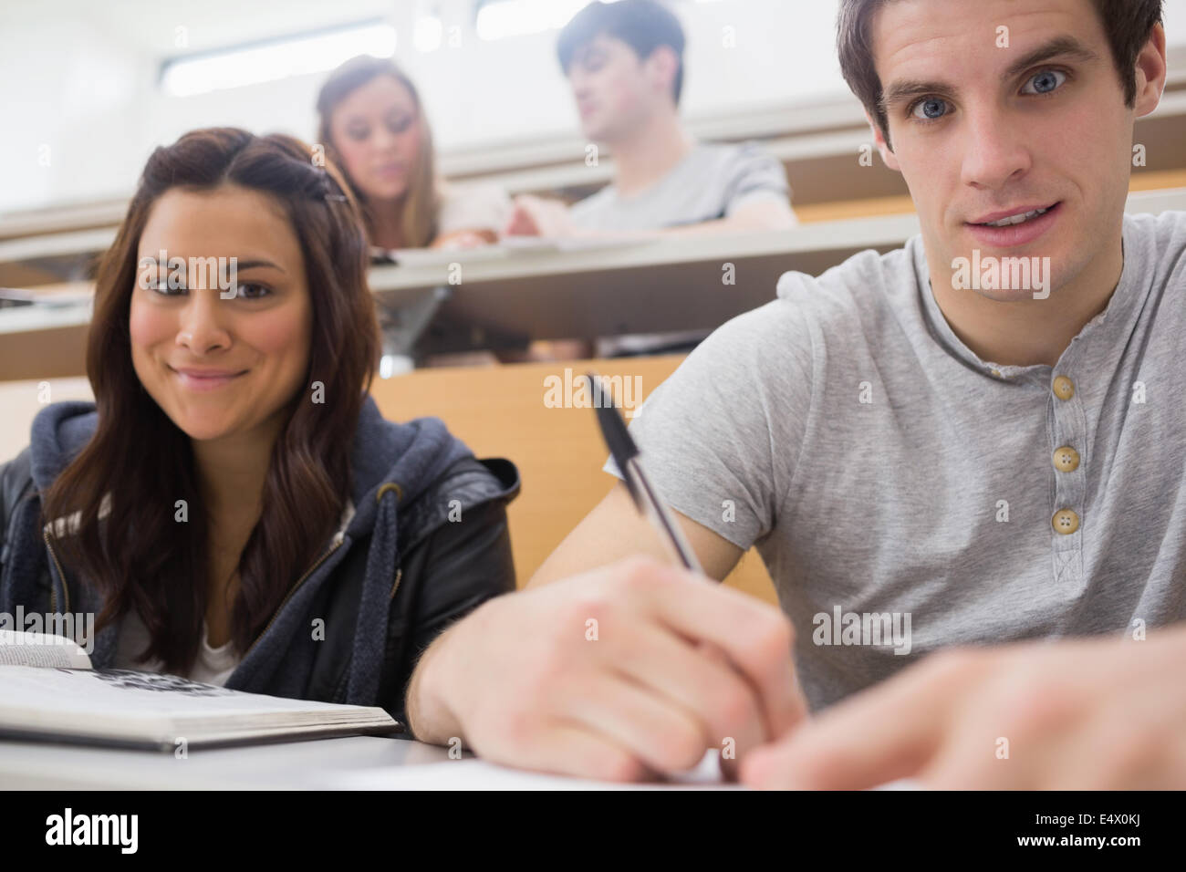 Students sitting at the desk smiling Stock Photo - Alamy