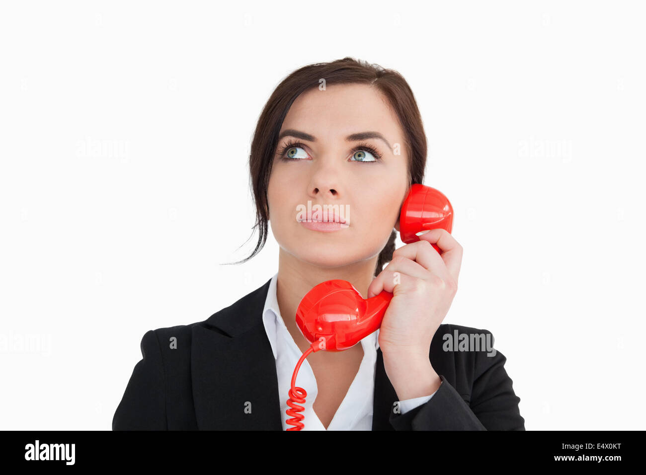 Woman in suit using a red dial telephone Stock Photo - Alamy