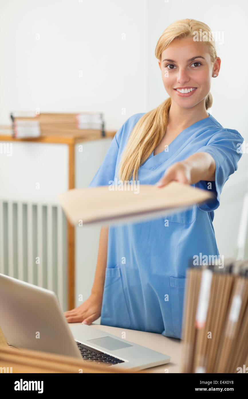 Nurse giving a folder Stock Photo - Alamy