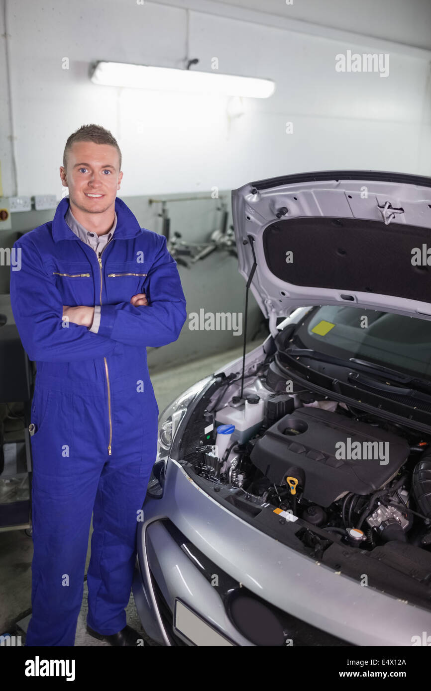 Smiling mechanic standing Stock Photo - Alamy