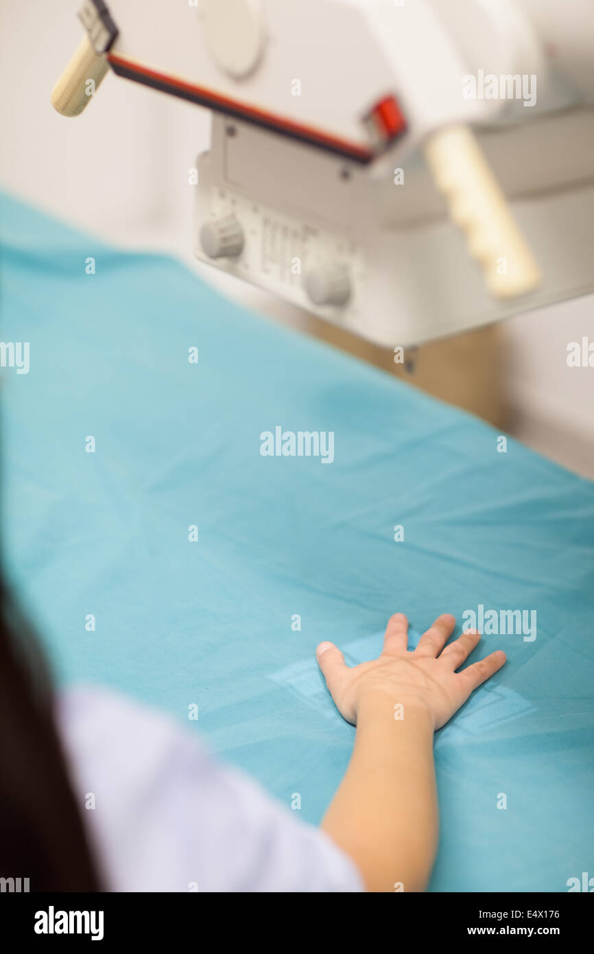 Woman placing her hand on a medical table Stock Photo - Alamy