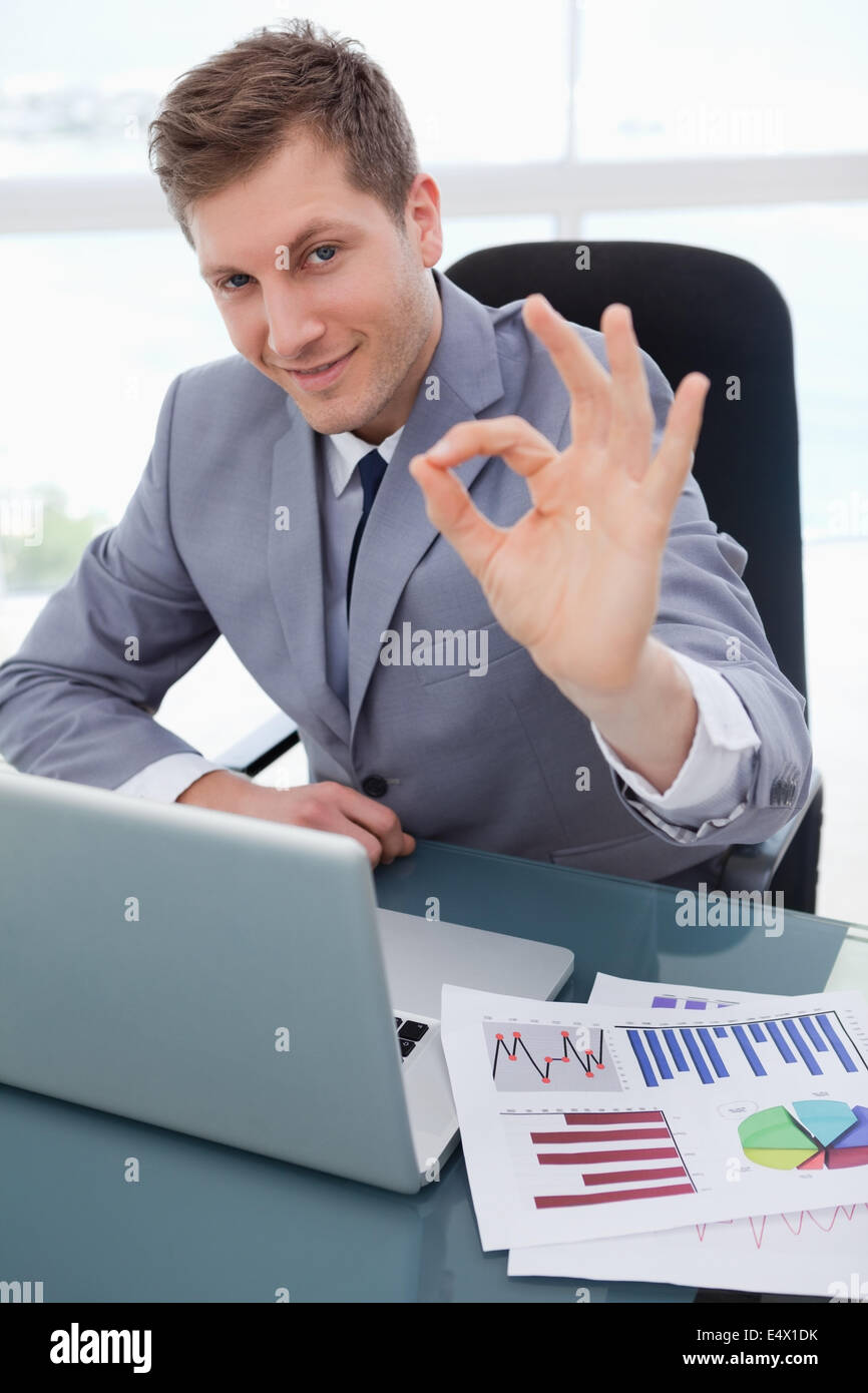 Businessman at his desk giving his approval Stock Photo - Alamy