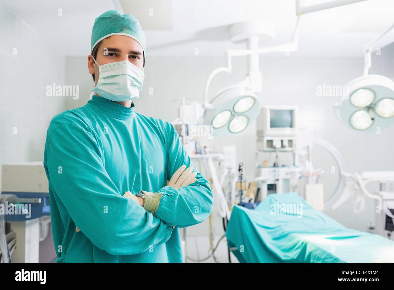 Serious surgeon standing with arms crossed Stock Photo - Alamy