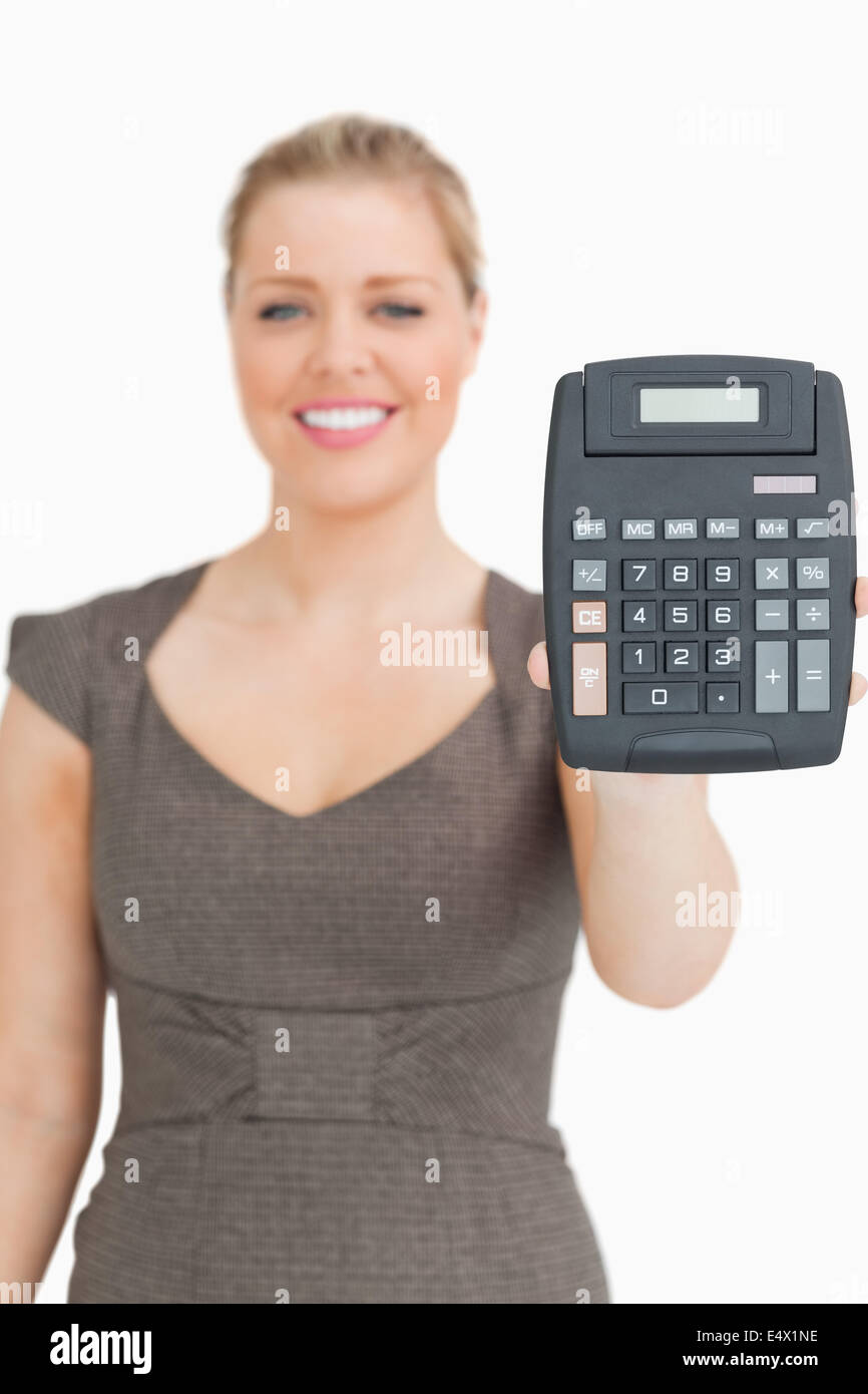 Smiling woman showing a calculator Stock Photo - Alamy