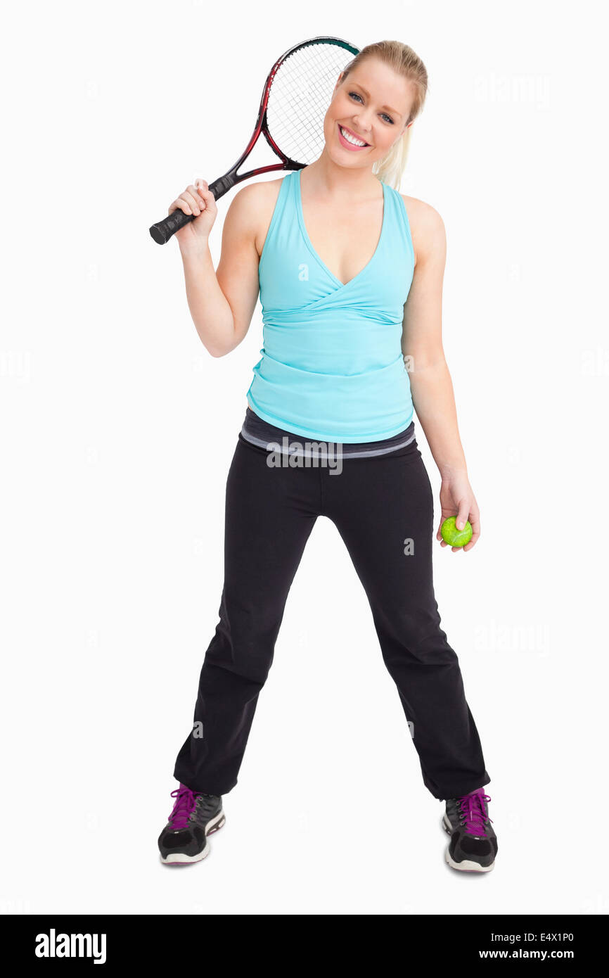 Happy young woman playing tennis Cut Out Stock Images & Pictures - Alamy