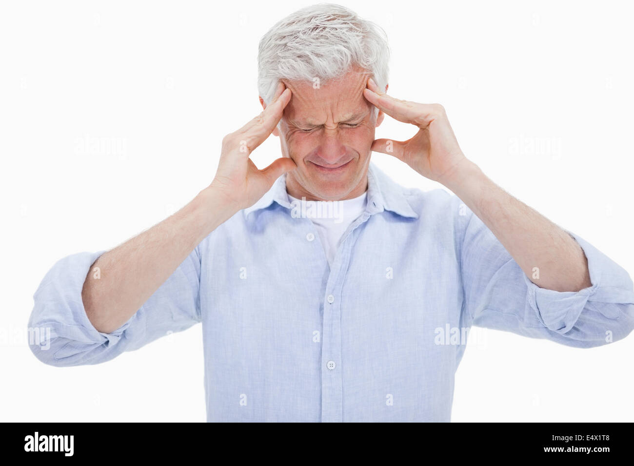 Exhausted man having a strong headache Stock Photo - Alamy