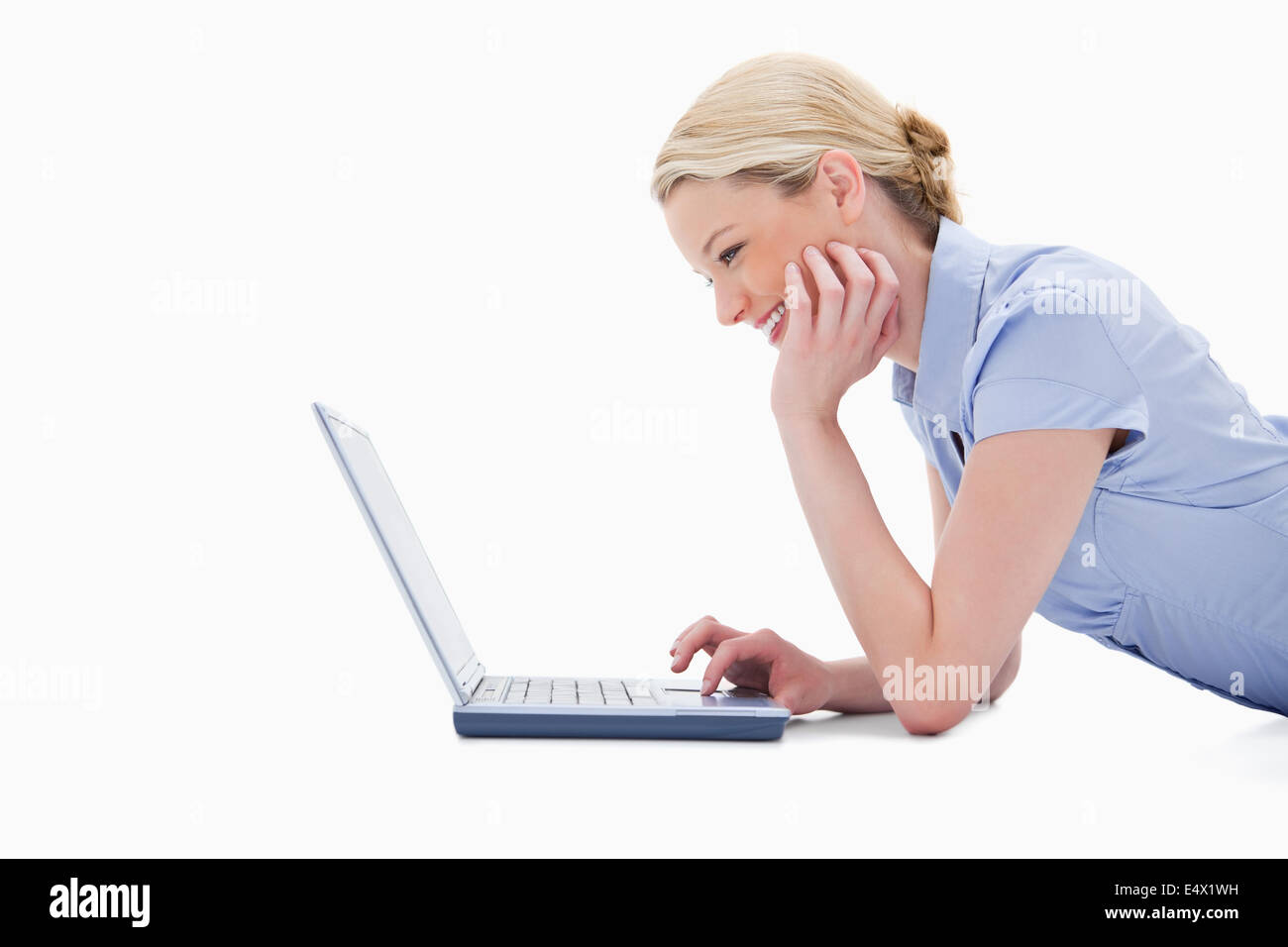 Side view of smiling woman using her laptop Stock Photo - Alamy