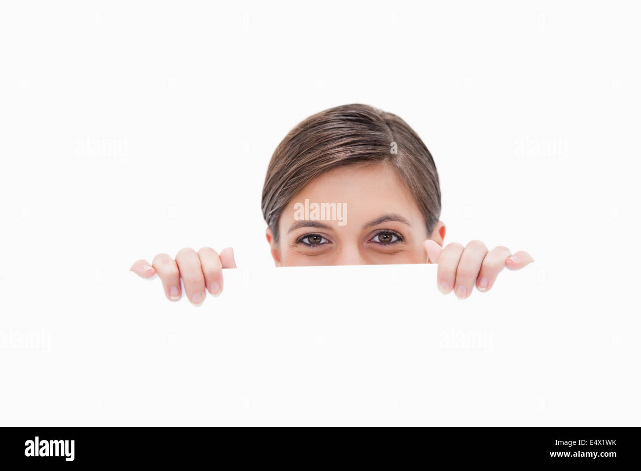 Woman having a look over blank wall Stock Photo - Alamy