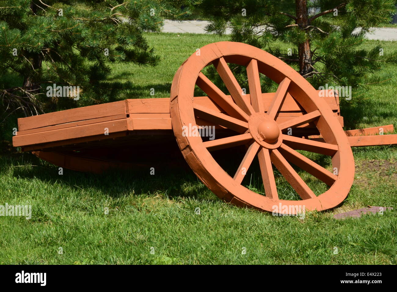 A broken cart painted red - used as decoration Stock Photo - Alamy