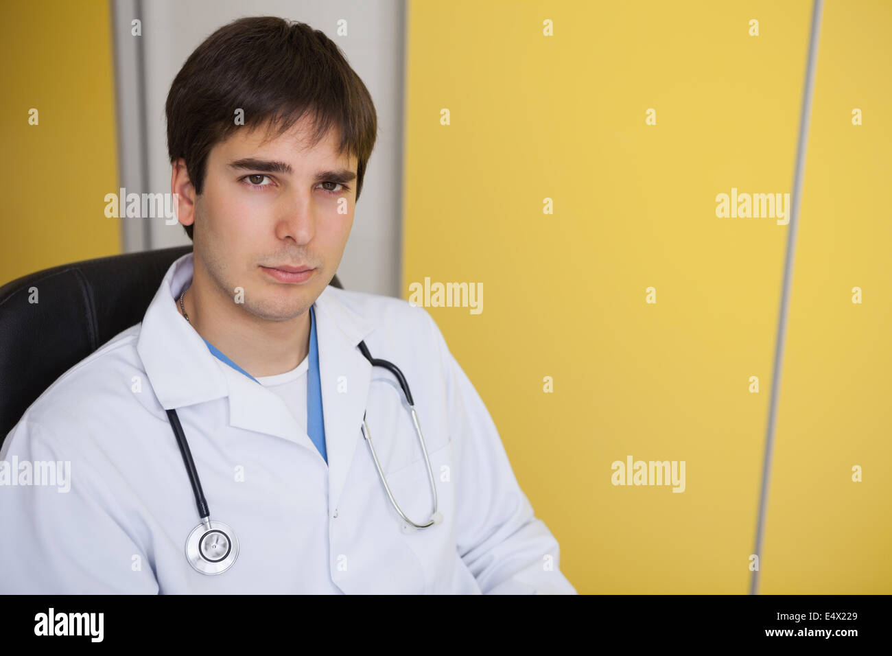 Doctor sits in yellow office Stock Photo - Alamy