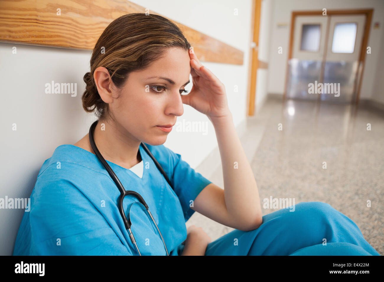Nurse sitting on floor thinking hi-res stock photography and images - Alamy