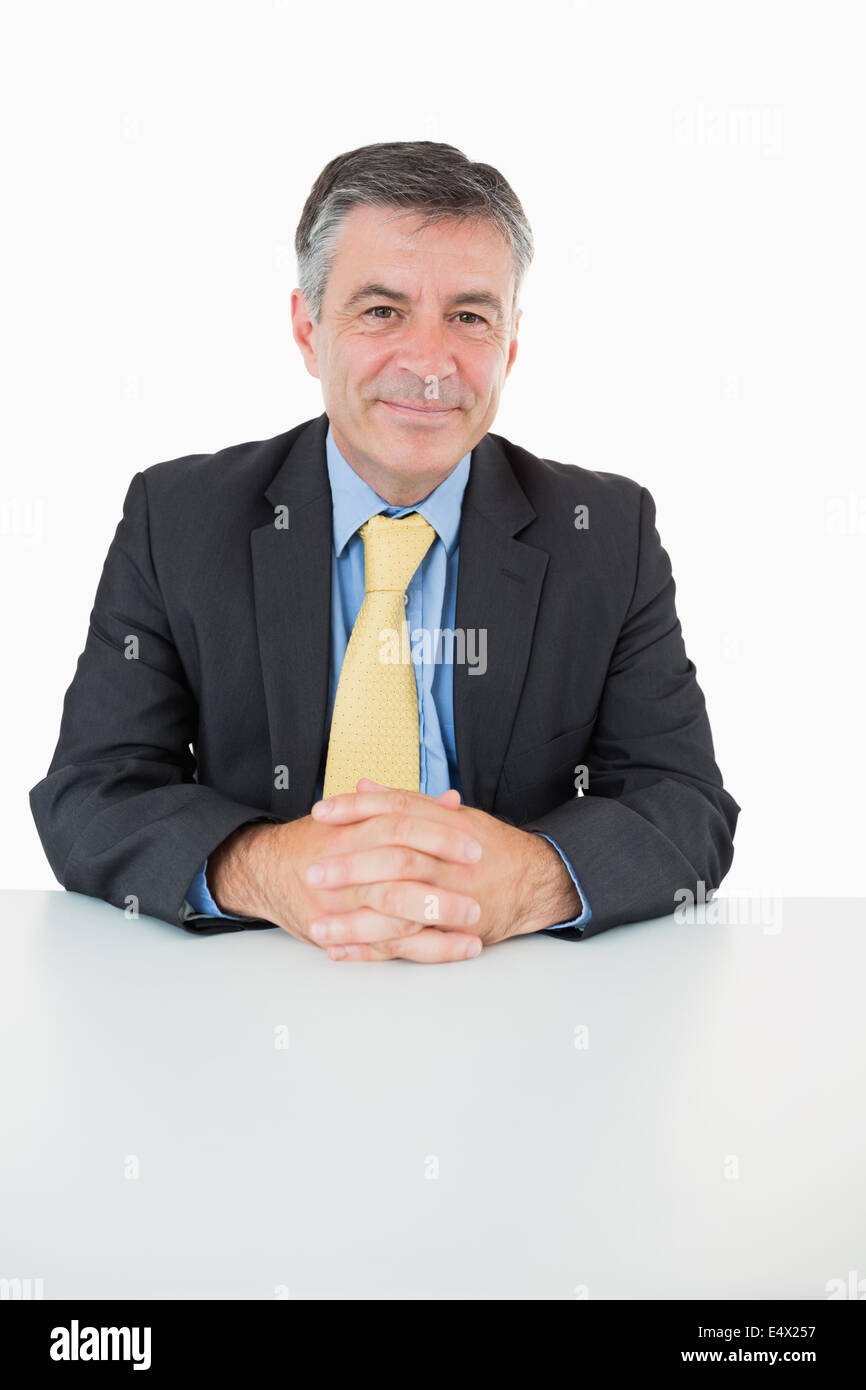 Happy man sitting at his desk Stock Photo - Alamy