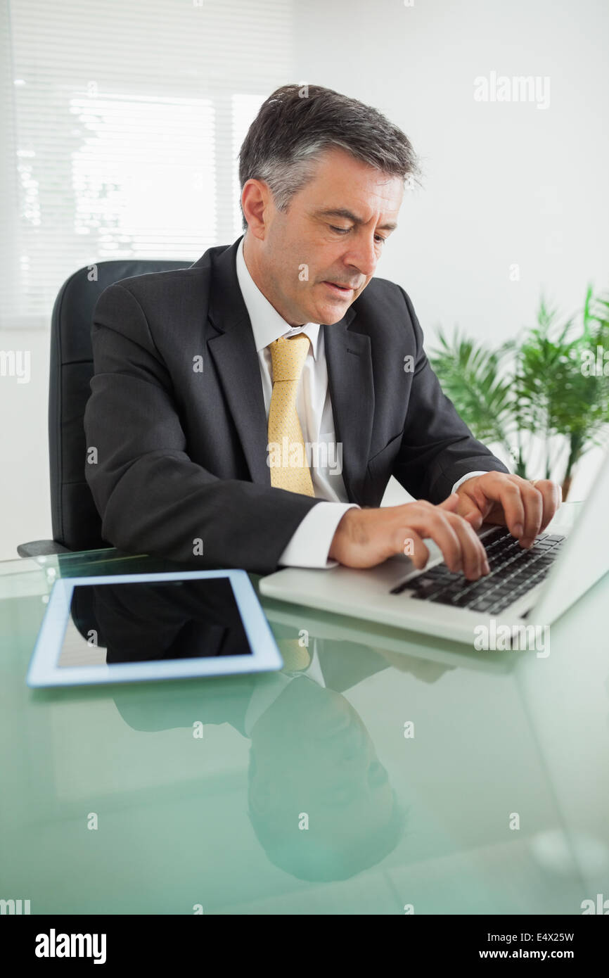 Concentrated business man working on laptop Stock Photo - Alamy