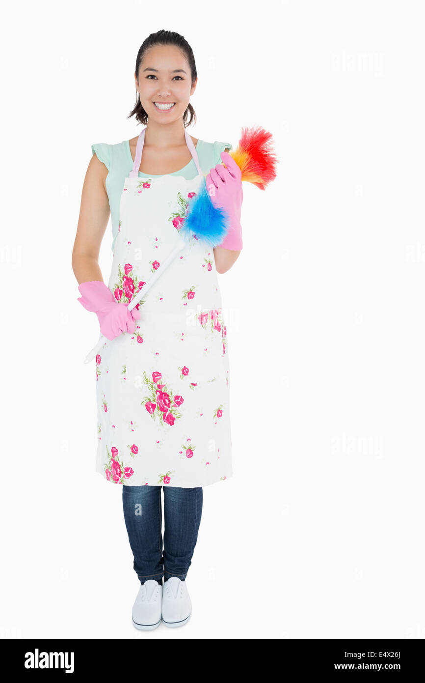 Woman standing with duster Stock Photo - Alamy