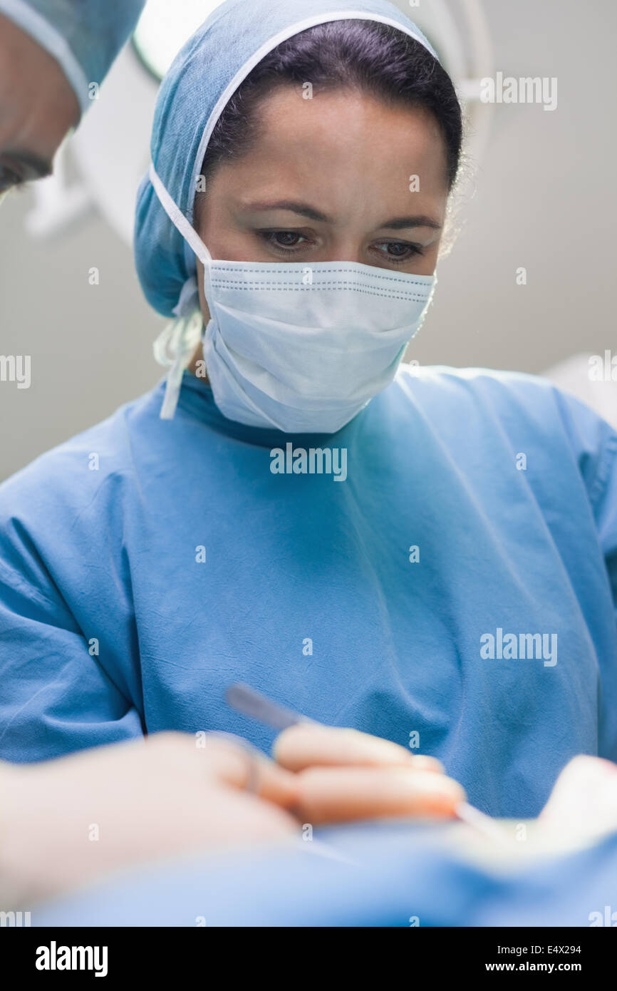 Doctor operating a patient Stock Photo - Alamy
