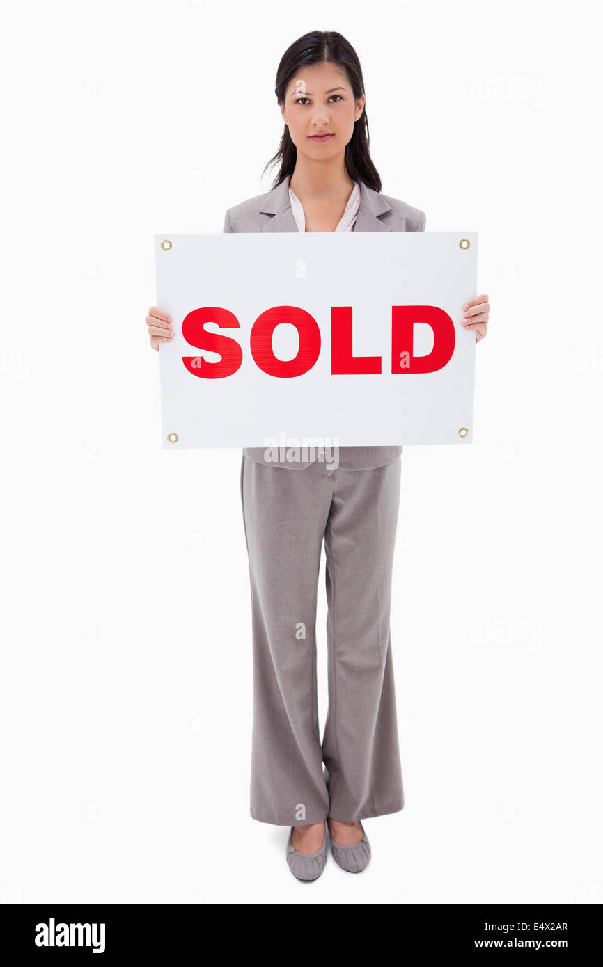 Real estate agent holding sold sign Stock Photo - Alamy