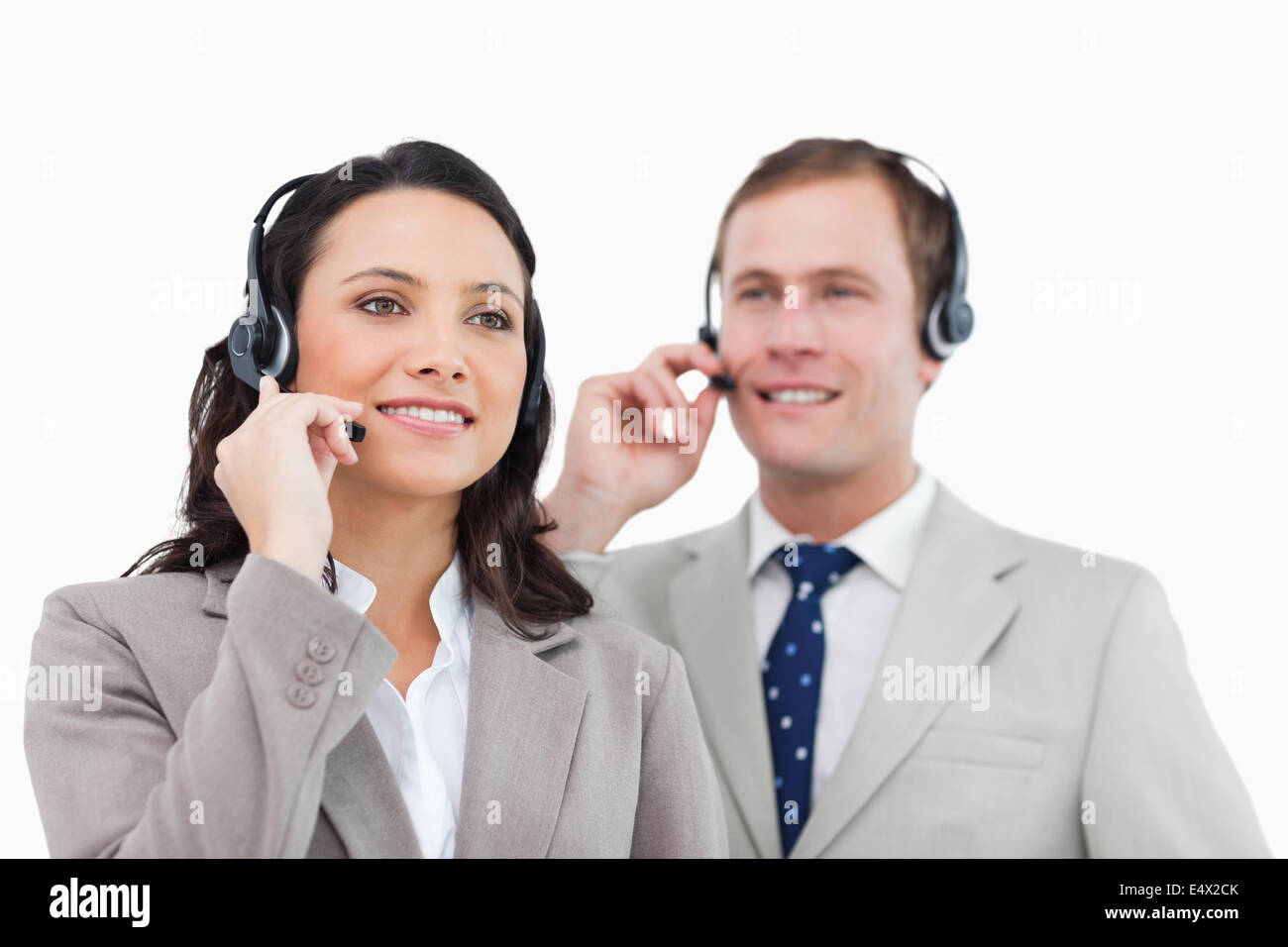 Telephone help desk employees with headsets Stock Photo - Alamy
