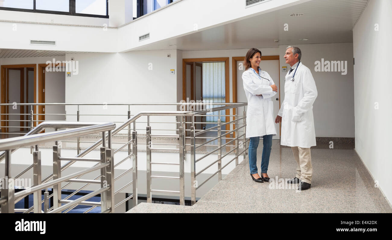 Two doctors talking to each other Stock Photo - Alamy