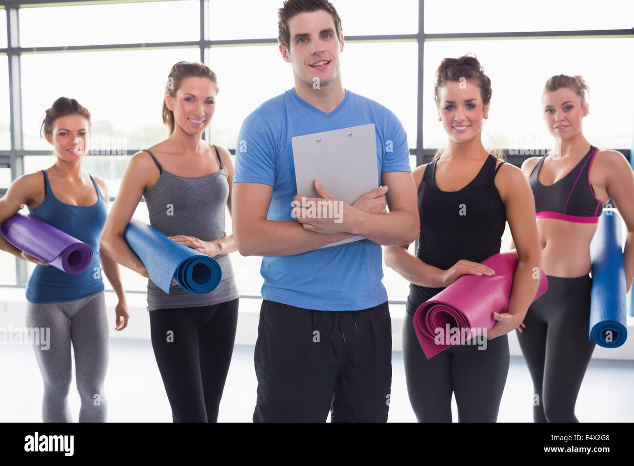 Trainer with his yoga class Stock Photo - Alamy