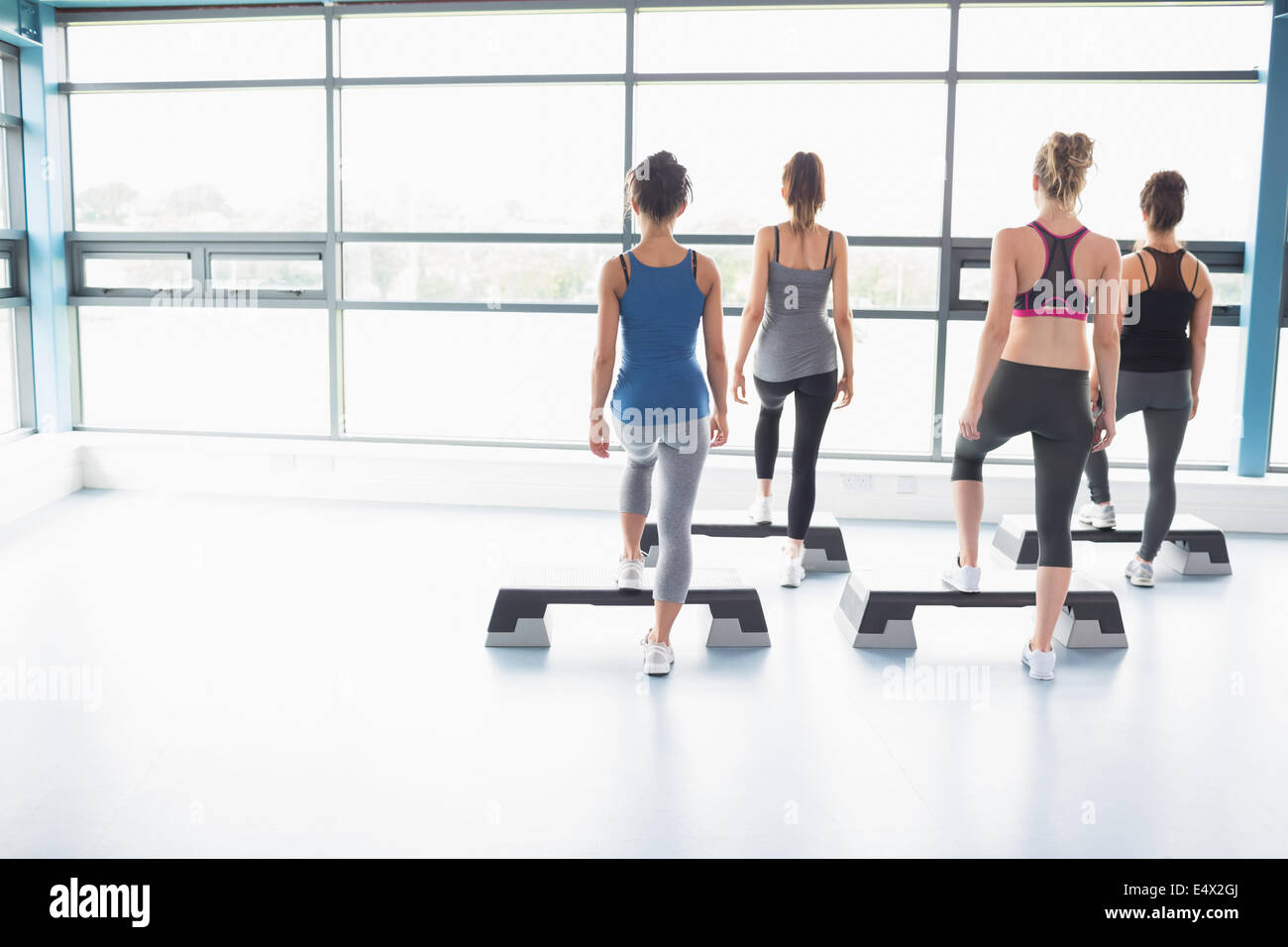 Four women stepping on boards Stock Photo - Alamy