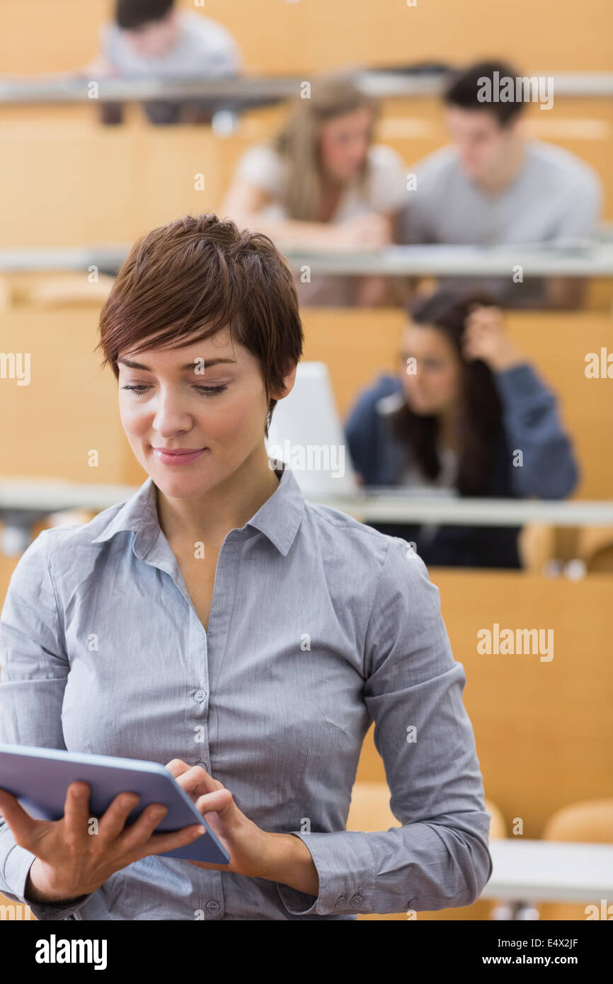 Teacher standing holding a tablet computer Stock Photo - Alamy