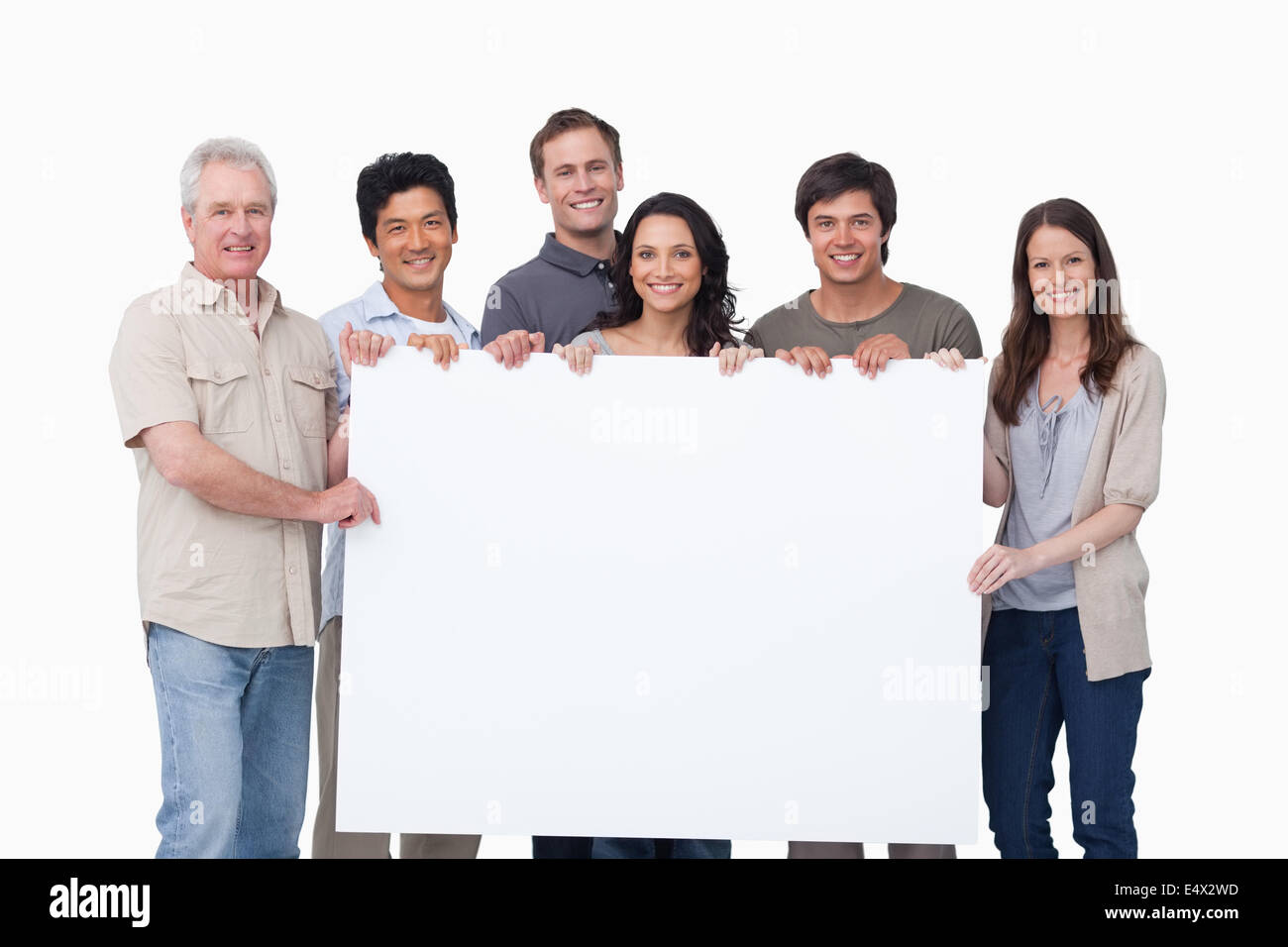 Smiling group holding blank sign together Stock Photo - Alamy