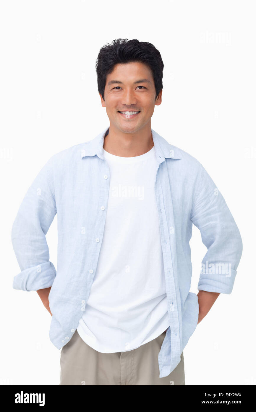 Smiling man with hands in his pockets Stock Photo - Alamy