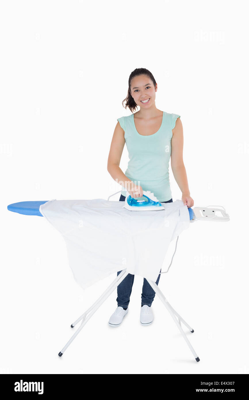Happy woman doing the ironing Stock Photo - Alamy