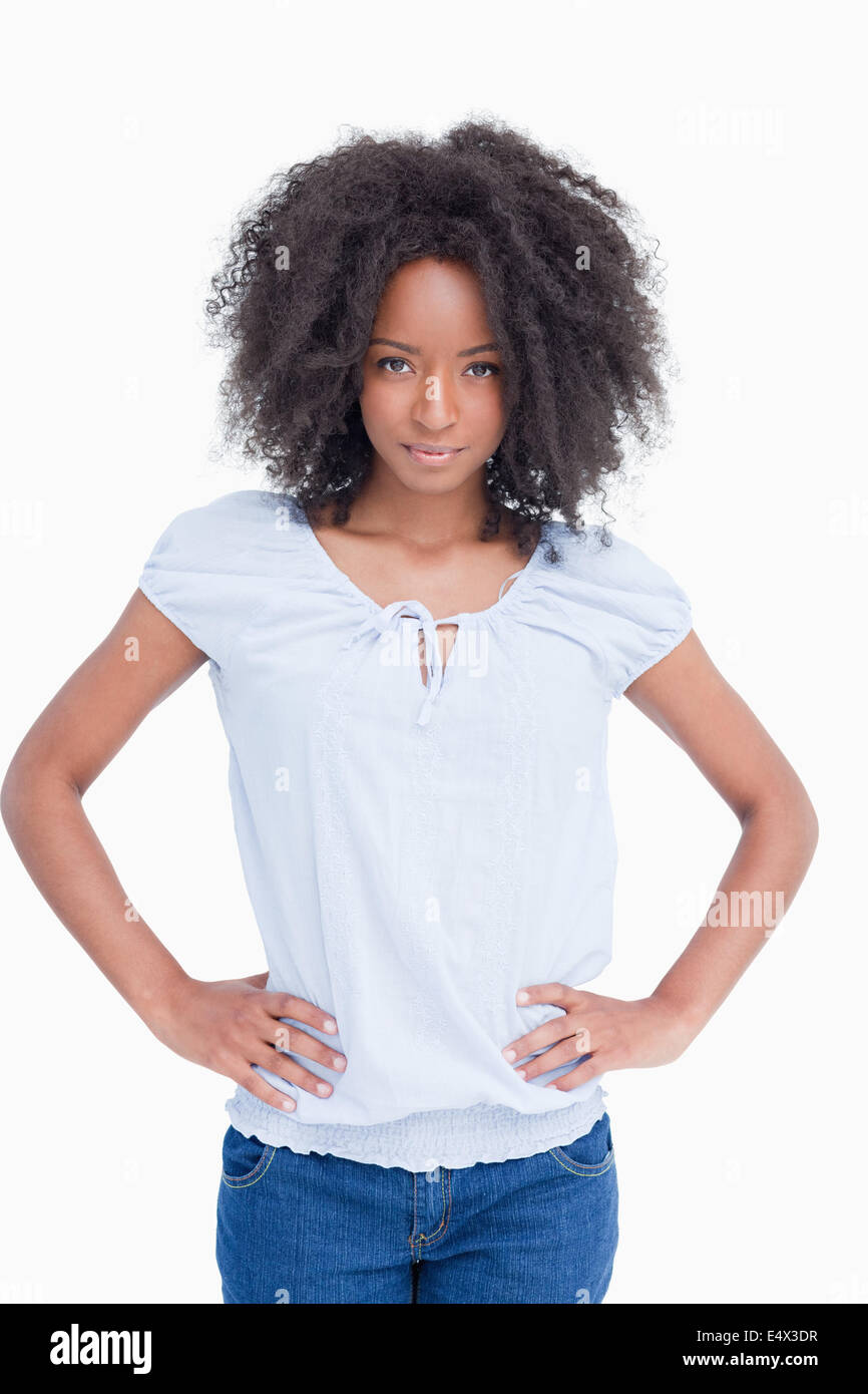 Serious woman placing her hands on her hips Stock Photo - Alamy