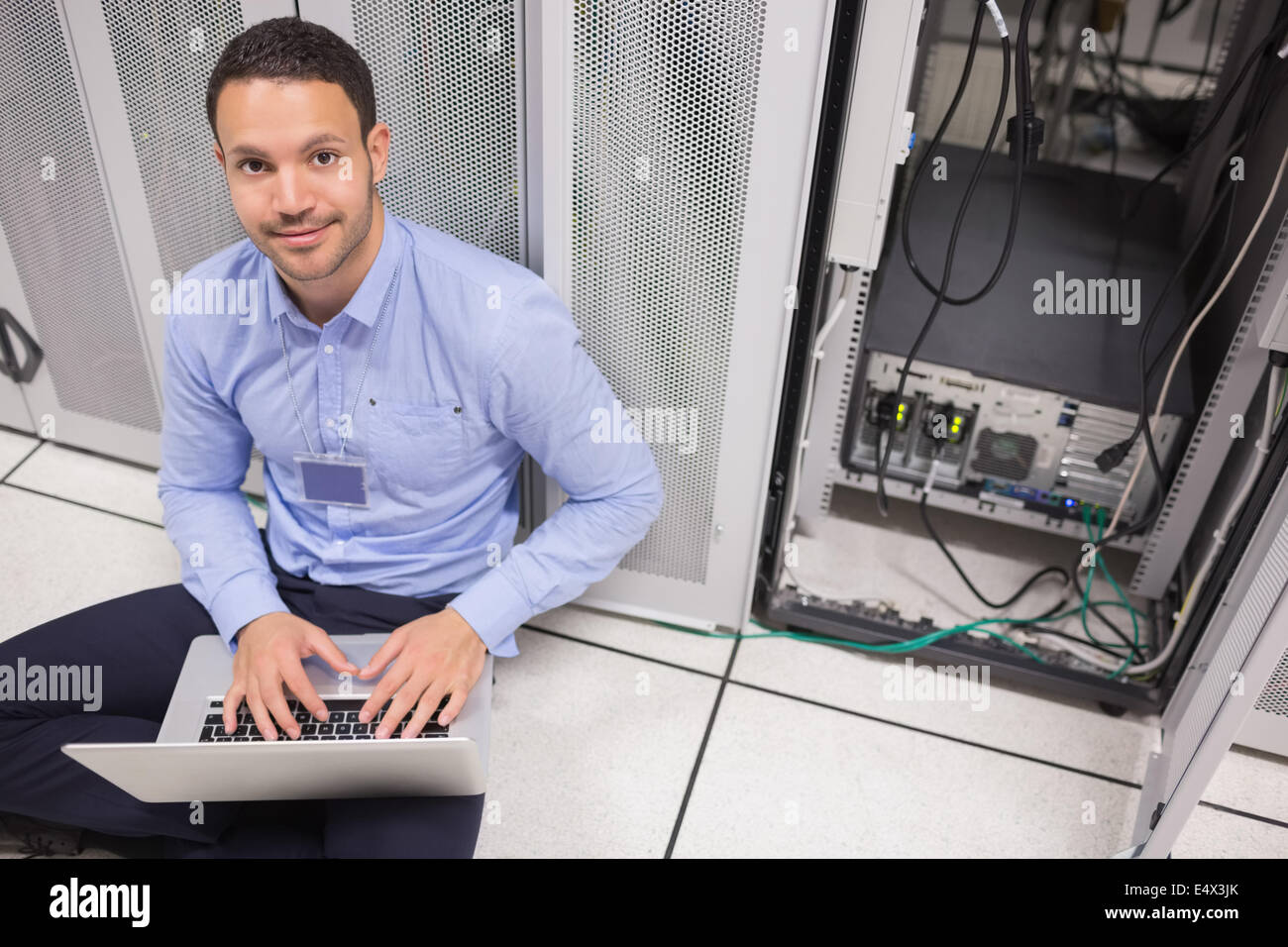 Man smiling while doing server maintenance Stock Photo - Alamy