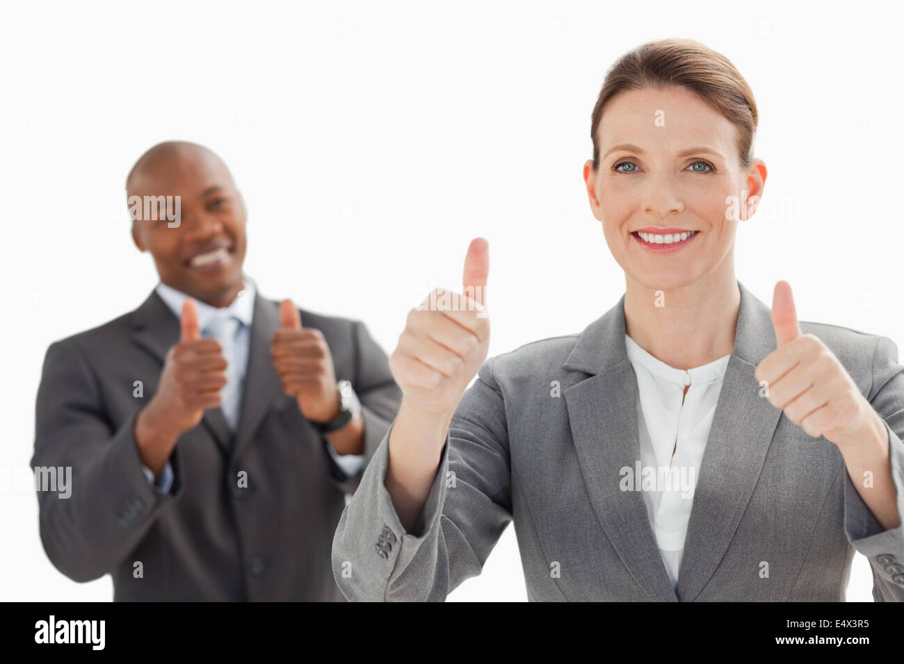 Smiling business people with thumbs up Stock Photo - Alamy