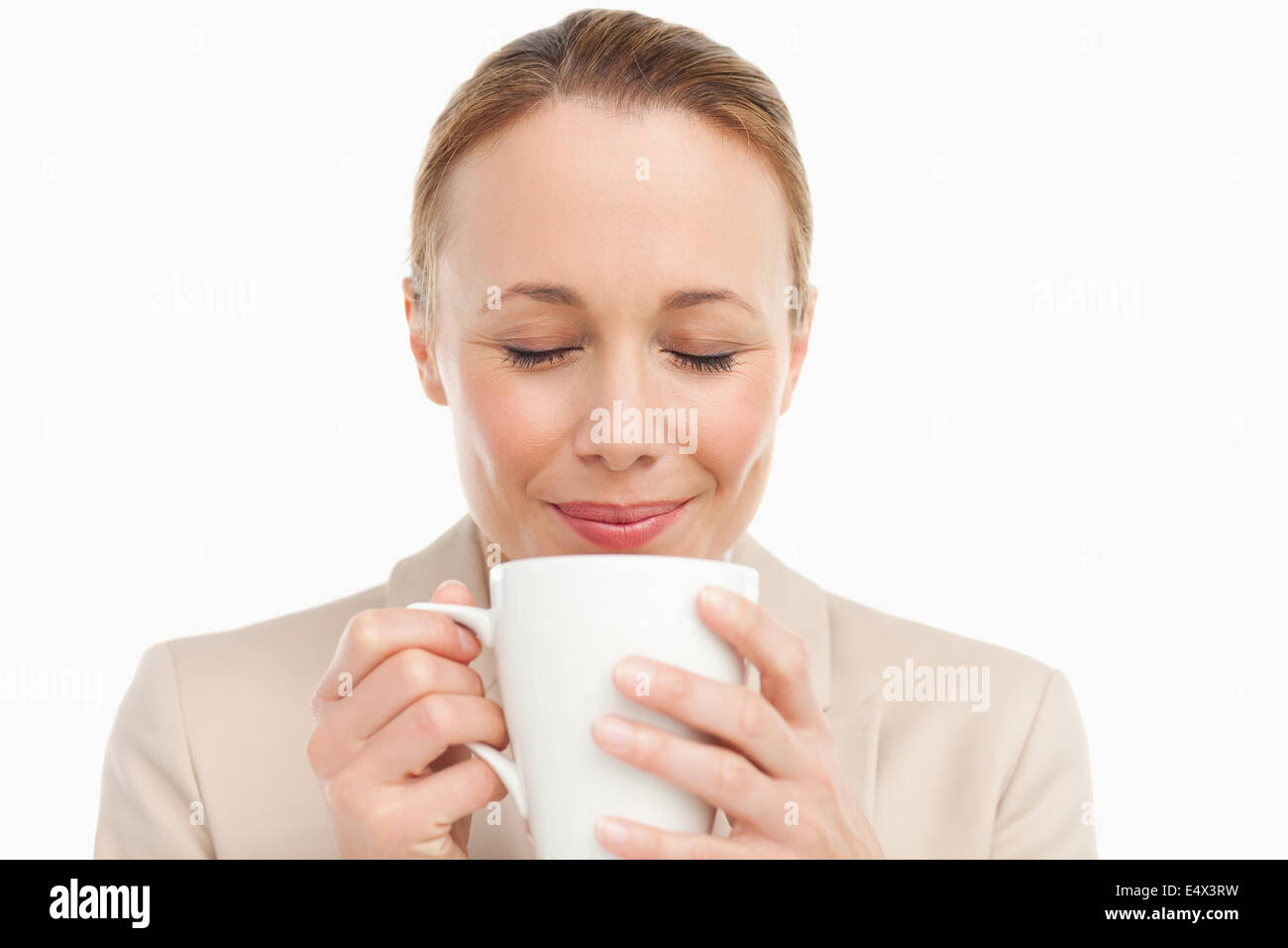 Woman in a suit smelling her tea Stock Photo - Alamy
