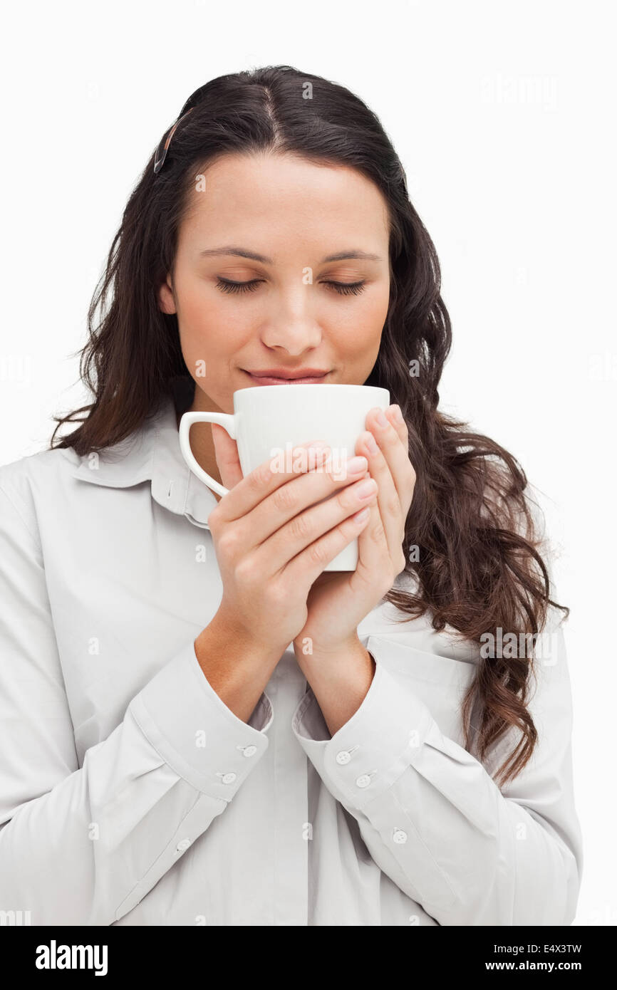 Brunette smelling a tea Stock Photo - Alamy