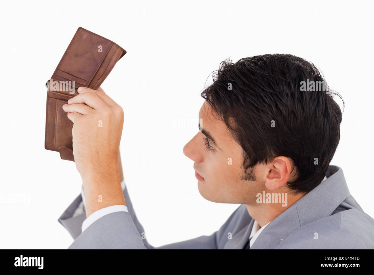 Man in a suit looking in his empty wallet Stock Photo - Alamy