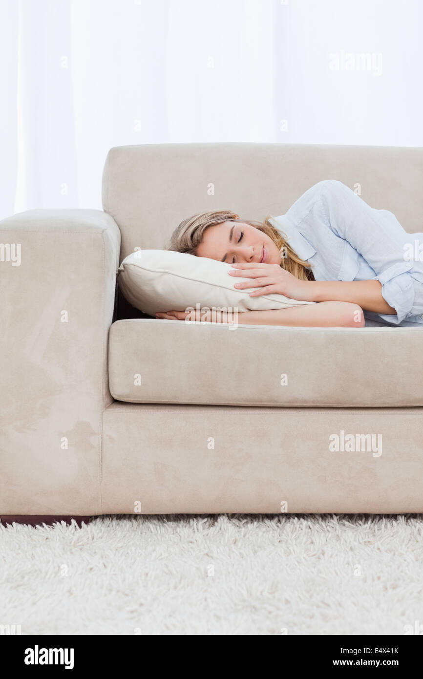 A woman is sleeping on a couch Stock Photo - Alamy