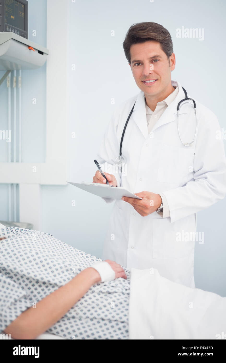 Doctor writing on medical chart hi-res stock photography and images - Alamy