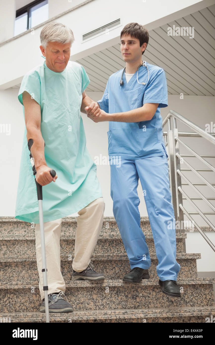 Male nurse assisting a patient Stock Photo - Alamy