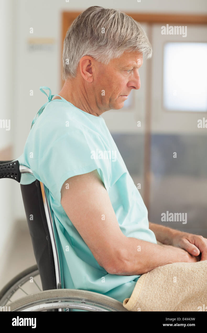 Sad man sitting in a wheelchair Stock Photo - Alamy