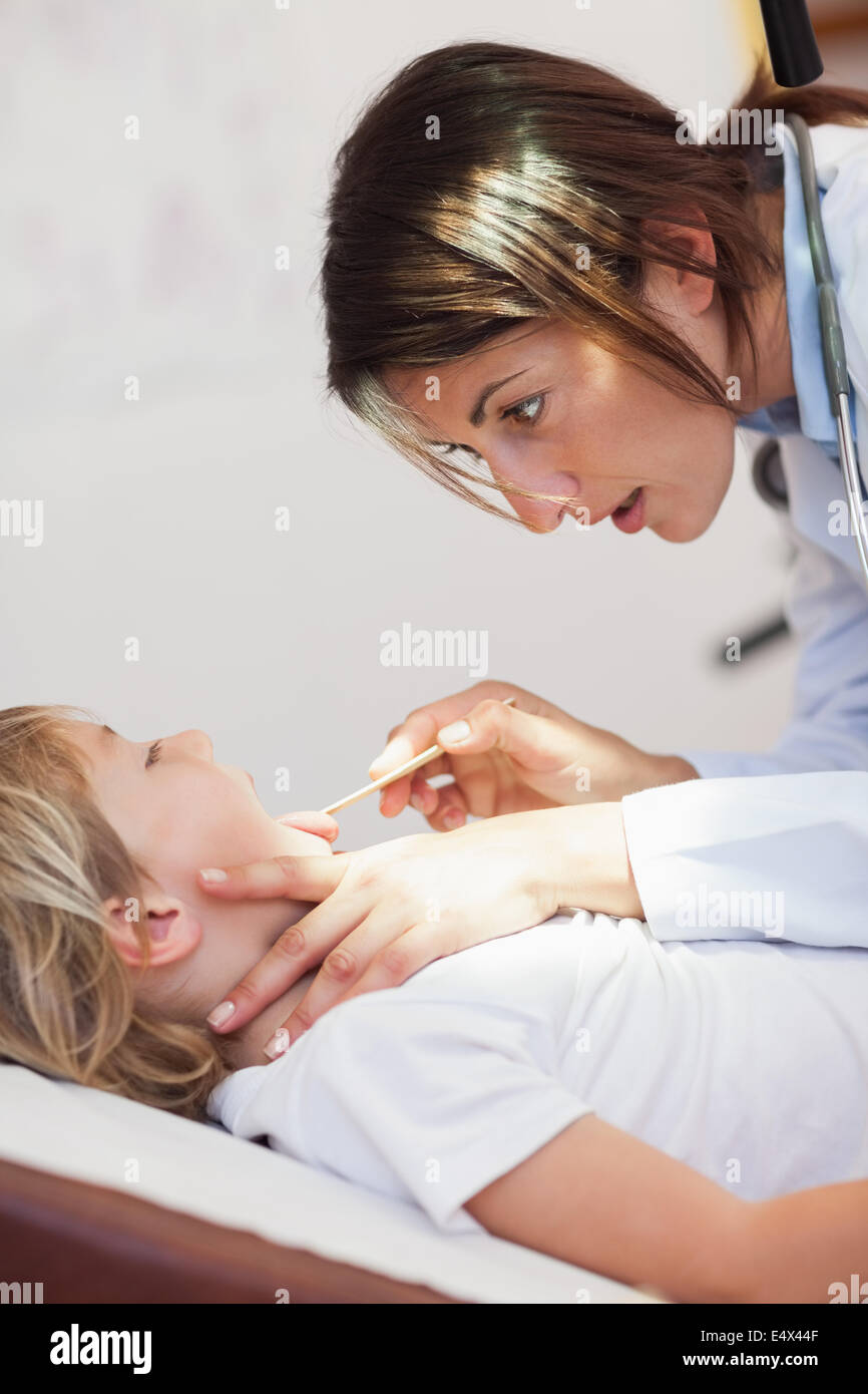 Serious doctor examining a child Stock Photo - Alamy