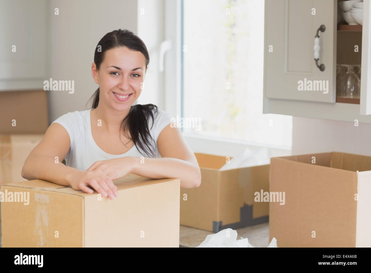 Happy woman unpacking Stock Photo - Alamy