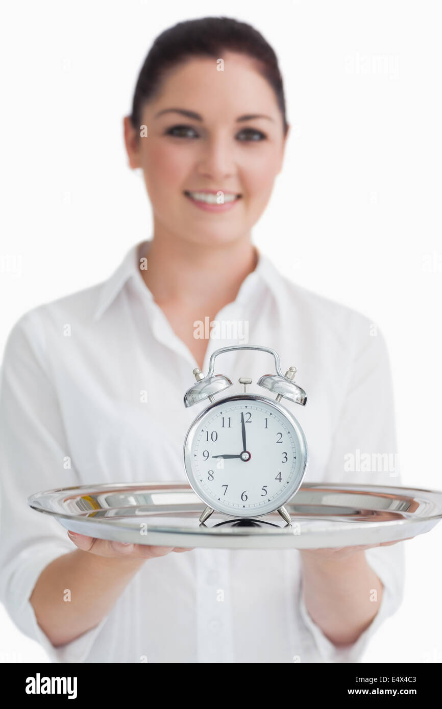 Waitress holding tray with alarm clock Stock Photo - Alamy