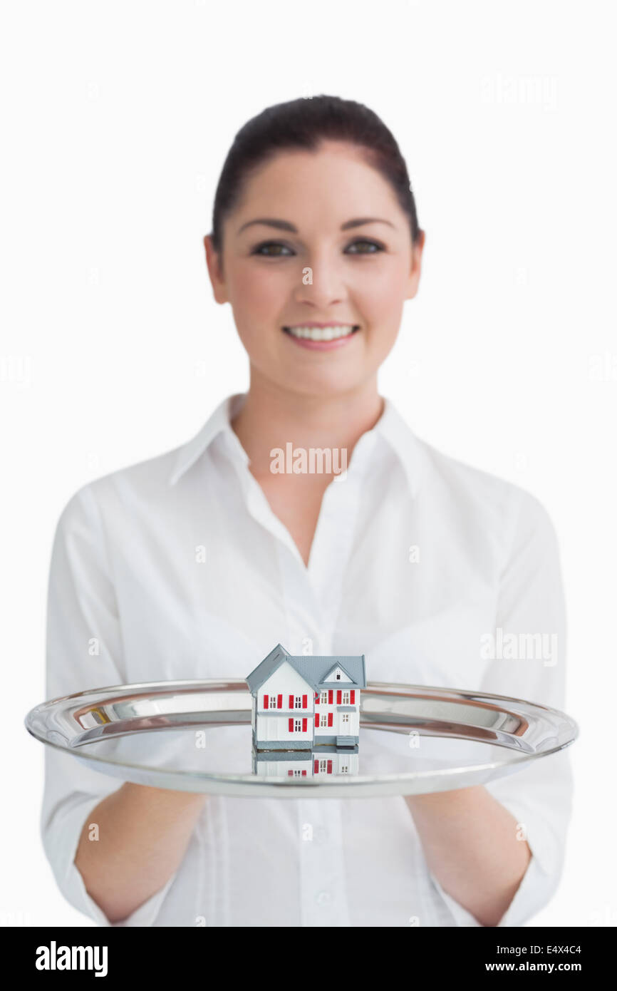 Waitress holding a little house Stock Photo - Alamy