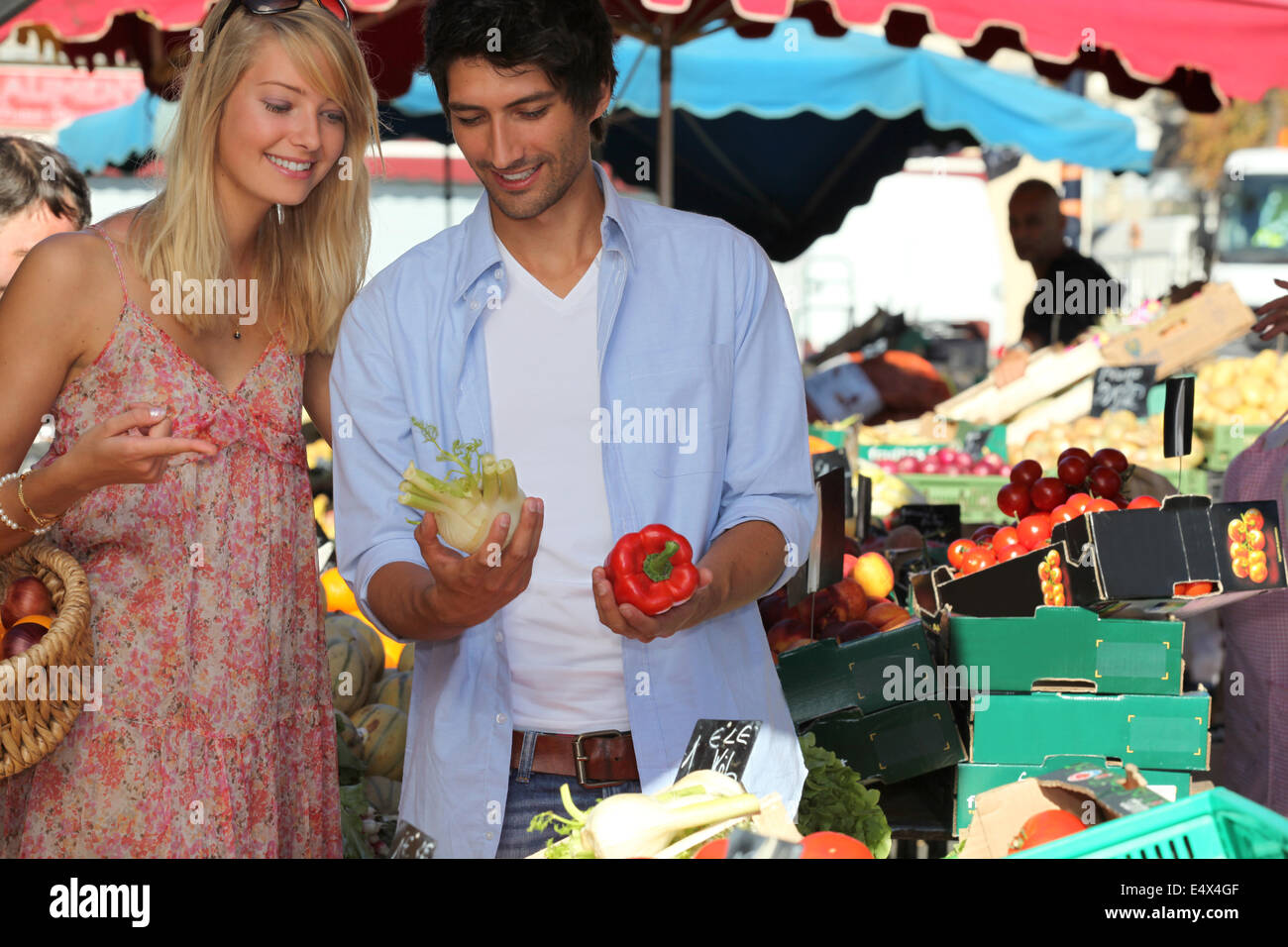 Couple choosing vegetables at the market Stock Photo - Alamy