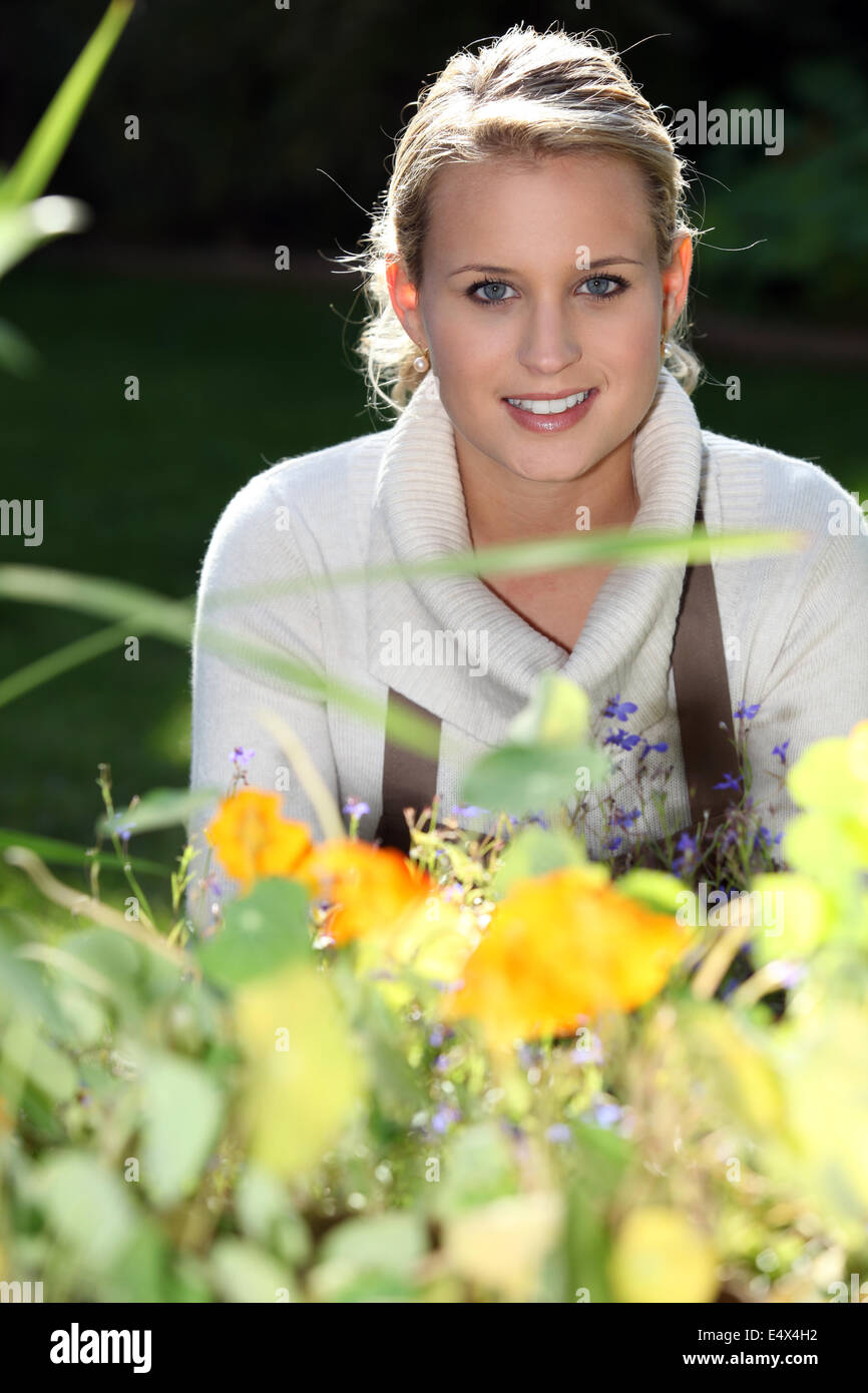 young woman standing behind flowers Stock Photo - Alamy