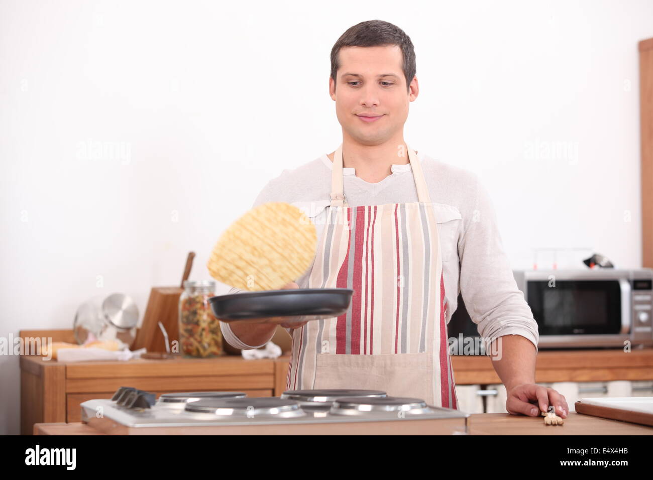 Man flipping pancake Stock Photo - Alamy
