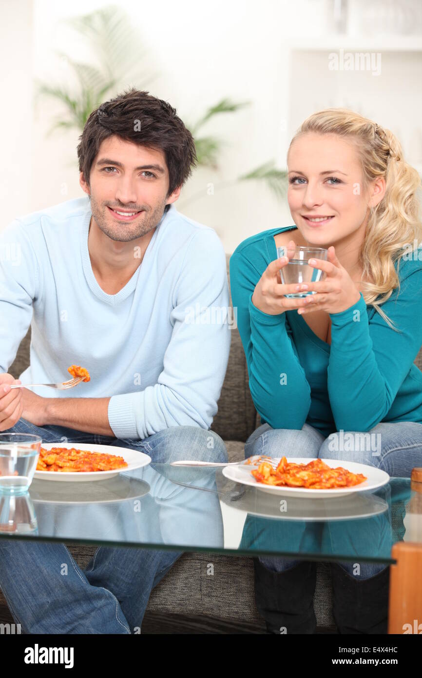 young couple eating ravioli Stock Photo - Alamy