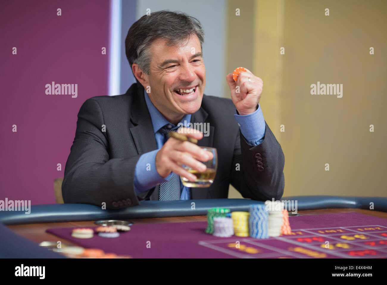Man winning at roulette table Stock Photo - Alamy
